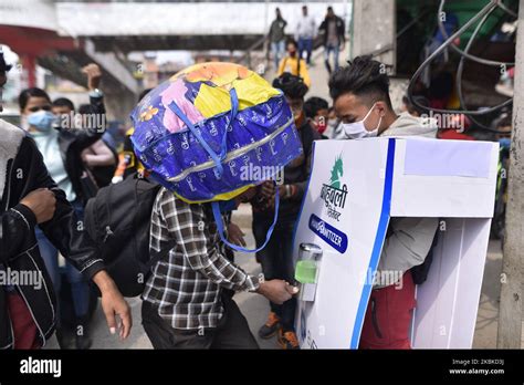 Nepalese People Using Mobile Hand Sanitizer Which Stop Spread And Cause