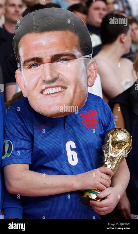 An England Fan Wearing A Harry Maguire Mask With A Replica Of The Fifa