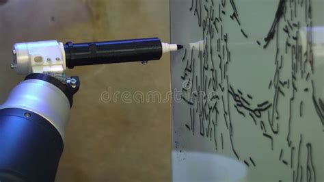 futuristic robot arm drawing portrait of woman on whiteboard stock