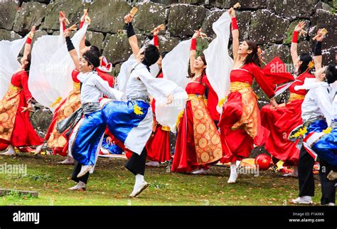 Japanese Yosakoi Dance Team Dancing In Front Of Castle Stone Wall Wearing Red Happi Coats With