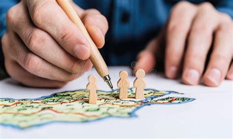 A Person Maps Out A Strategy With Wooden Figures On A Map Highlighting