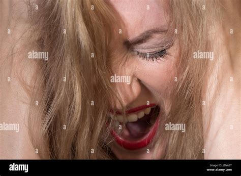 Close Up Image Of Caucasian Woman With Sandy Blond Hair Showing Emotion