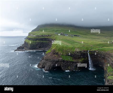 Aerial View Of Gasadalur Village And Mulafossur Waterfall In The Faroe