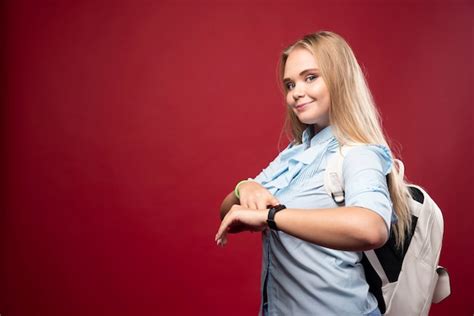 Une Jeune étudiante Blonde Retourne à Lécole Et Vérifie Lheure Sur Sa Montre Photo Gratuite