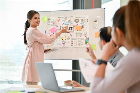 A Confident Asian Female Tech Developer Led The Meeting With Her Team Brainstorming A New