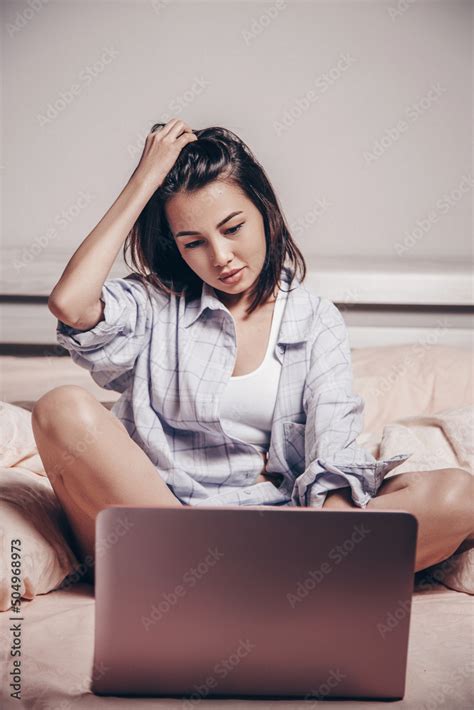 A Young Asian Webcam Model Girl Is Sitting In Front Of A Laptop With