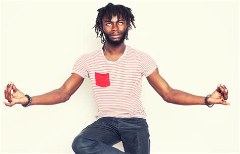 Young Handsome Afro American Guy Relaxing In Goofy Lotos Isolated Stock
