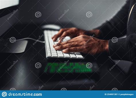 Your Data Is Always At Risk An Unrecognisable Hacker Using A Computer In The Dark Stock Image