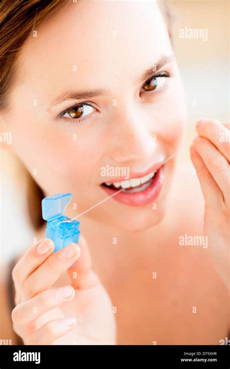 Woman Using Dental Floss Stock Photo Alamy