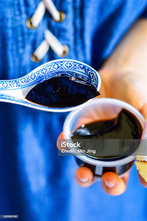 Woman Spoons Up Black Guiling Gao A Jellylike Chinese Medicine Stock