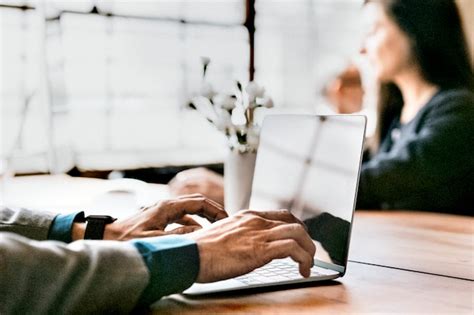 Premium Photo Man Using A Laptop On A Wooden Table