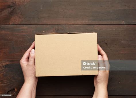 갈색 크래프트 종이의 직사각형 골판지 상자를 들고 두 손 형판에 대한 스톡 사진 및 기타 이미지 형판 소포 손 Istock