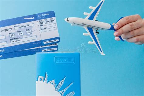 Passport Plane And Air Ticket In Woman Hand On A Blue Background