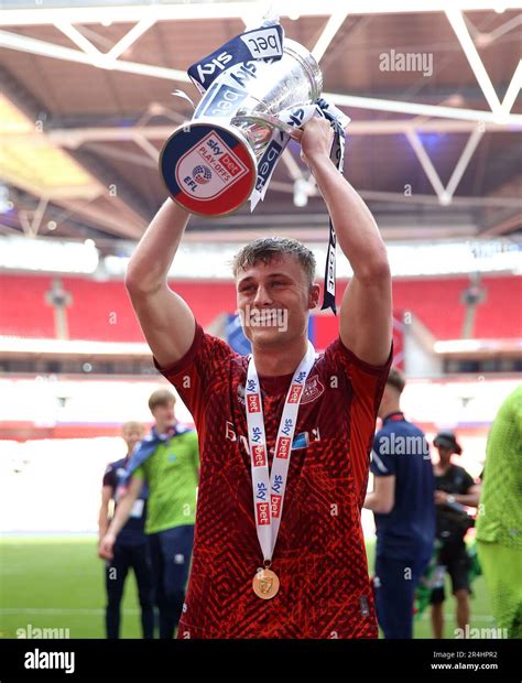 Carlisle Uniteds Owen Moxon Celebrates With The Trophy After Being