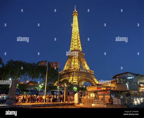 Shining Eiffel Tower At Night Reflected In The Seine People Enjoying The Night Scenery Paris
