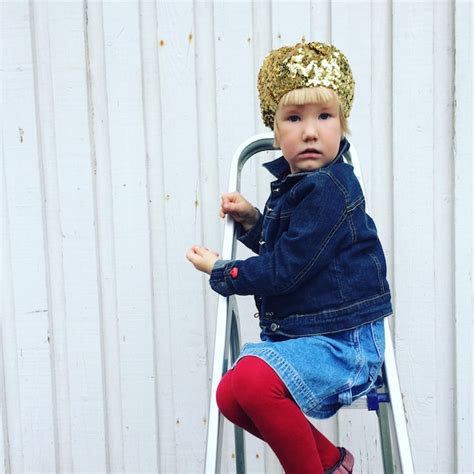 Premium Photo Portrait Of Girl Sitting On Ladder Against White Wall