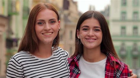 Joyful Young Women Sharing A Playful Moment Blowing Kisses Stock