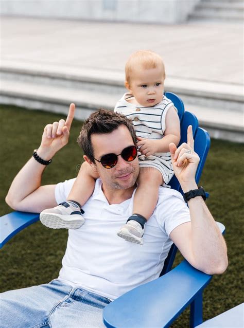 Stylish Father In Sunglasses And His Little Son Are Having Fun While