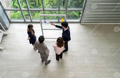 Professional And Diverse Business Team Stand Together Engaged In A Brainstorming Session Using