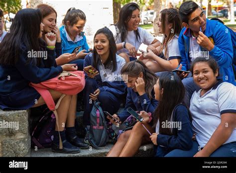 Argentina Students Busy With Their Mobile Phones On The Square Of
