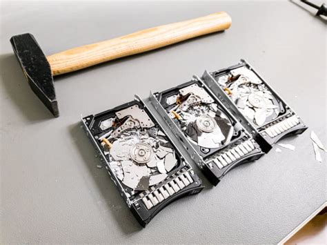 Three Hard Disk Drives With Shattered Platter On A Table Stock Photo