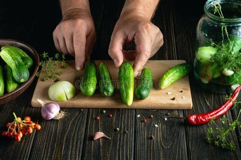 Chef Hands Close Up While Sorting Cucumbers On The Kitchen Table