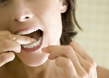 How To Floss Properly For Healthy Teeth And Gums Livestrong