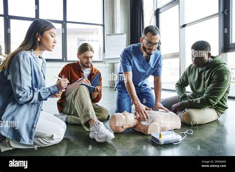 Cardiac Resuscitation Skills Healthcare Worker Applying Defibrillator Pads On Cpr Manikin Near