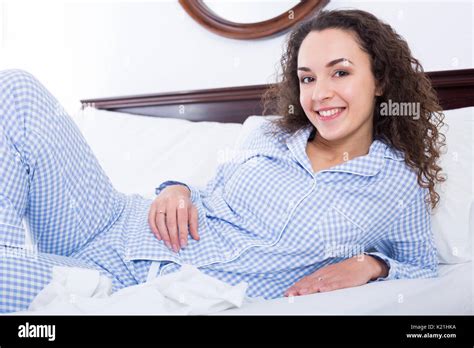 Brunette Girl Posing With Blue Pygamas In Bed At Home Stock Photo Alamy