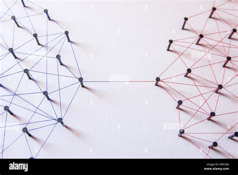 Connecting Networks Concept Two Network Connected With Yarn Red And Blue On White Paper