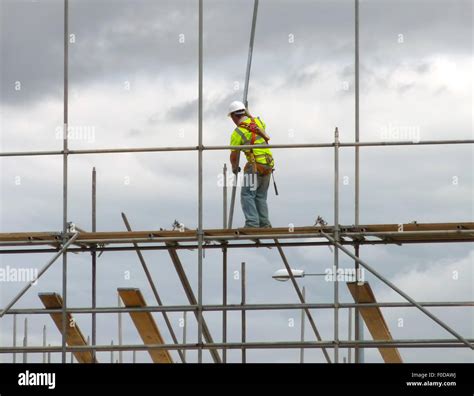 Closeup Of Construction Worker Assembling Scaffold On Building Site