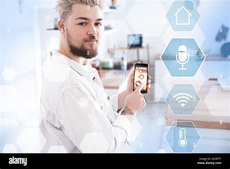 Man With Mobile Phone Using Application Of Smart Home Automation In Room Stock Photo Alamy