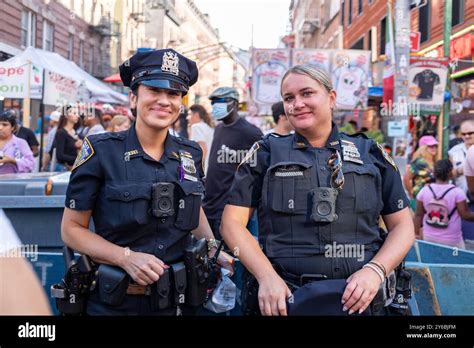 Two Smiling Nypd Officers Pose For The Camera In Their Uniforms