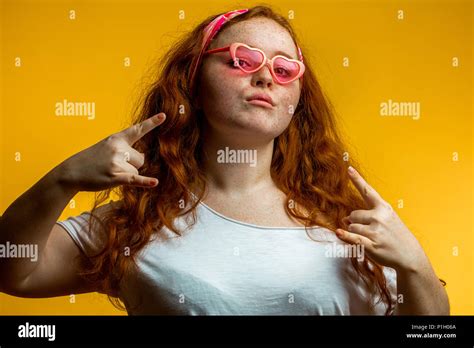 Portrait Of Beautiful Smiling Redhead Girl Wearing Big Pink Glasses