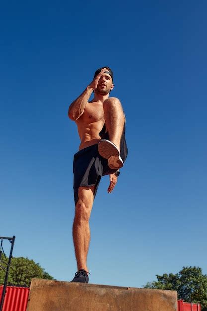 Premium Photo Sporty Physically Fit Man Doing Stepup Exercise On Wooden Box While Doing Gym