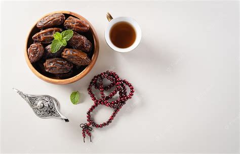 Premium Photo Dates Fruit Aladdin Lamp And Rosary Beads On Gray