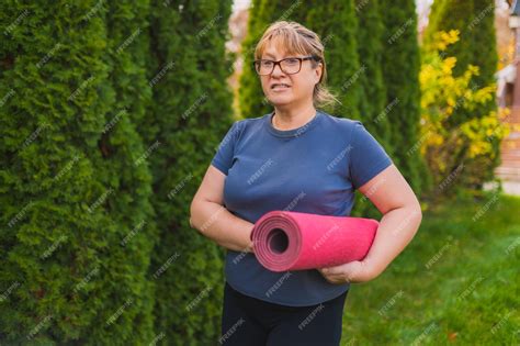 Premium Photo Mature Female On Outdoor Yoga Retreat Walking Along
