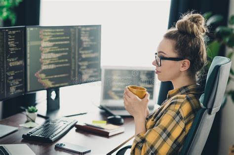 Female Programmer Working On Coding Tasks At A Modern Workspace With