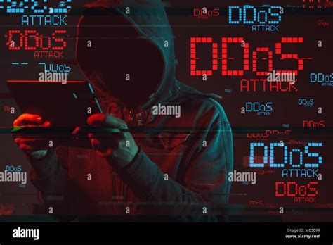 Distributed Denial Of Service Or Ddos Attack Concept With Faceless Hooded Male Person Using