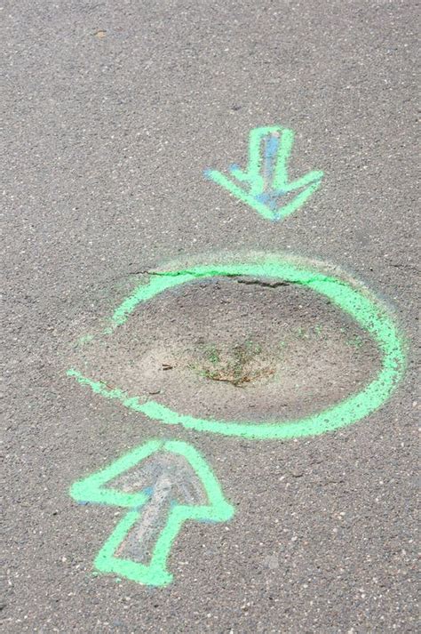 Vertical Shot Of Two Arrows Pointing At A Circle Painted On The Ground Stock Image Image Of