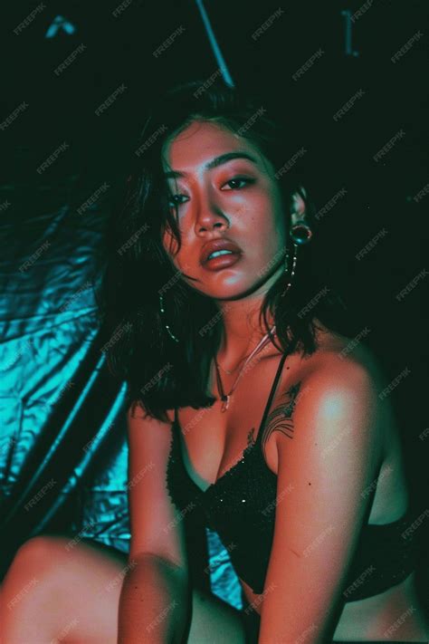 Premium Photo An Alluring Woman In A Black Bikini Lounging Sensually On A Bed