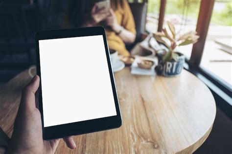 Premium Photo Hand Holding Mock Up Tablet Pc In Cafe With People