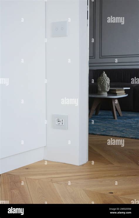 A Close Up On A Modern Apartment S Doorway With A Light Switch And A Power Socket Outlet