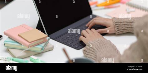 Close Up View Of Female Student Doing Assignment With Digital Tablet
