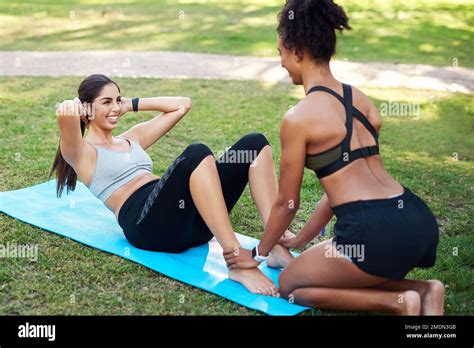Keep Going Full Length Shot Of Two Attractive Young Women Sitting And Performing Core Exercises