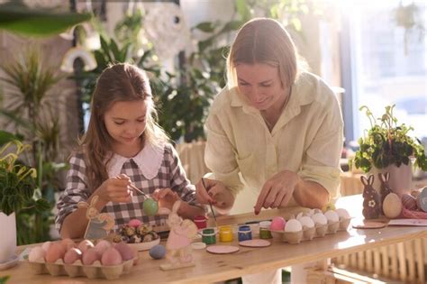 Premium Photo Girl And Her Mom Coloring Easter Eggs