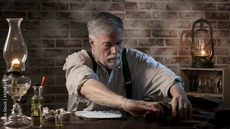 A Scene From The Early American Pioneer Era Of A Man Preparing To