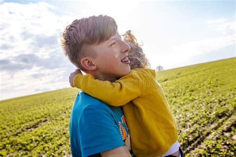Brother And Sister Play Outside Girl Holds Older Brother By Neck And
