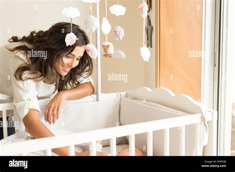 Mother Putting Baby To Sleep At The Crib Stock Photo Alamy