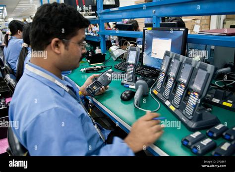 Workers Test Hand Held Inventory Computer Devices On The Assembly Line At The Venture Corp